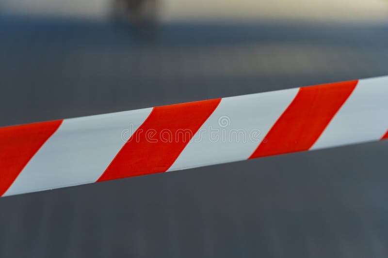 A Striking Pattern of Red and White Caution Tape Stretches Across an ...
