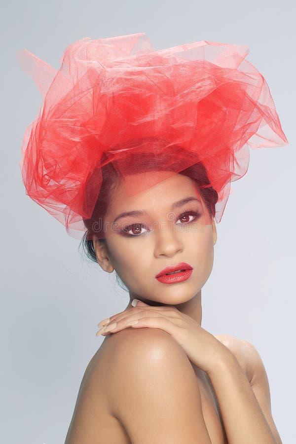 Striking Red Themed Woman with Creative Headpiece Stock Photo - Image ...