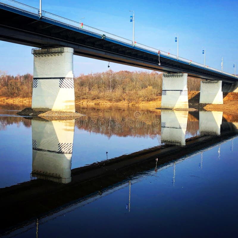 Modern Bridge Over a Calm River with Clear Reflections Stock Photo ...