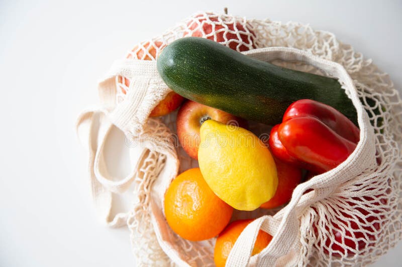 The String Bag of Natural Material with Fruits and Vegetables is on a ...