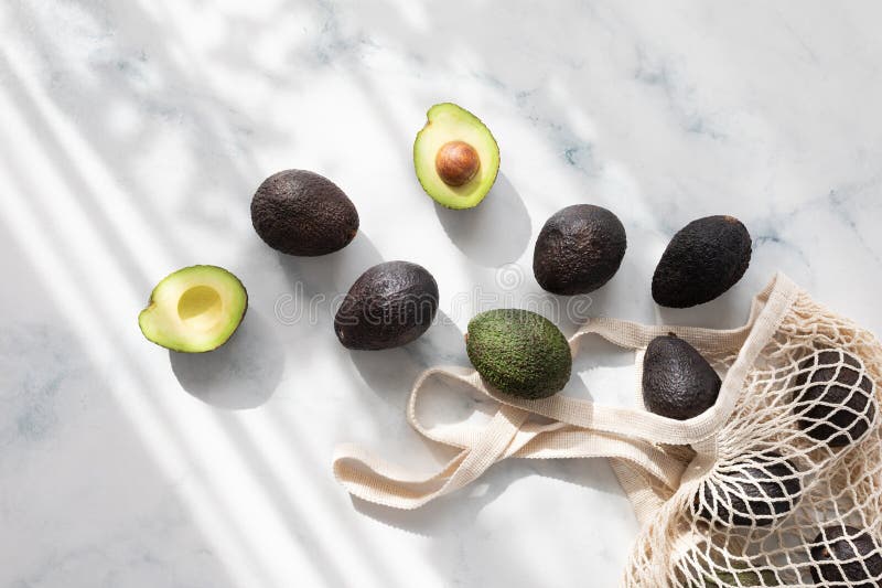 String Bag with Ripe Avocados on White Background in Aesthetic Shadow ...
