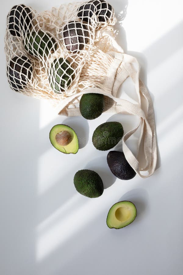 String Bag with Ripe Avocados on White Background in Aesthetic Shadow ...