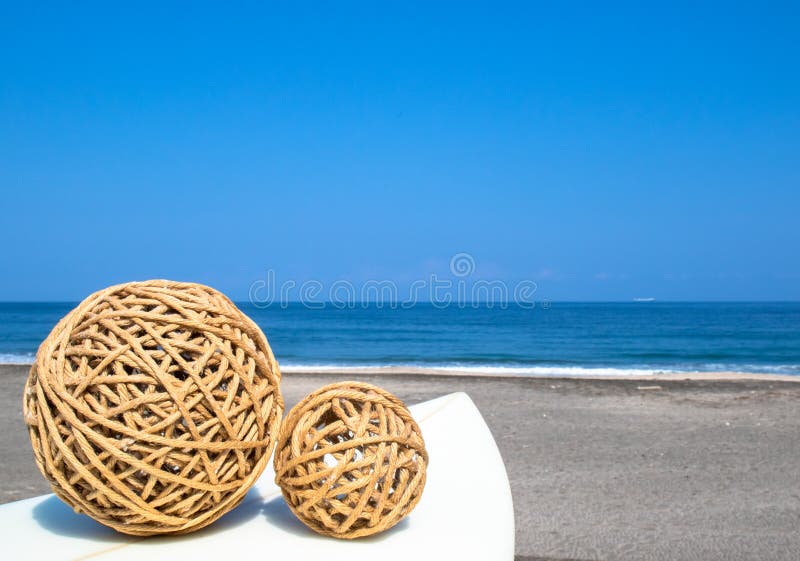 String Balls on a White Surfboard with Beach and Ocean Background Stock ...