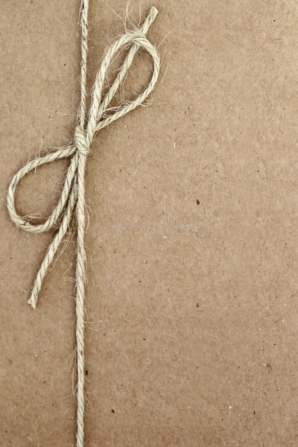String Bow on Brown Paper stock photo. Image of recycled - 22999590