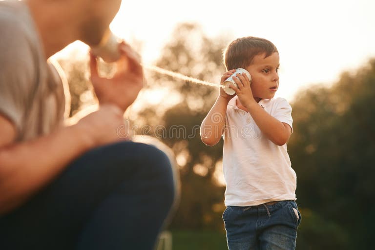 With String Can Phone. Father and Little Son are Playing and Having Fun ...