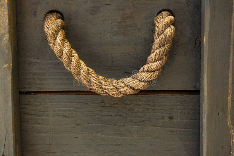 String Hanging on a Wooden Wall Stock Photo - Image of smile, brown ...