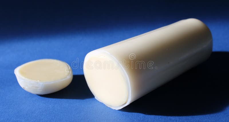 String Italian Cheese in a Paraffin Coating Isolated on Blue Background ...