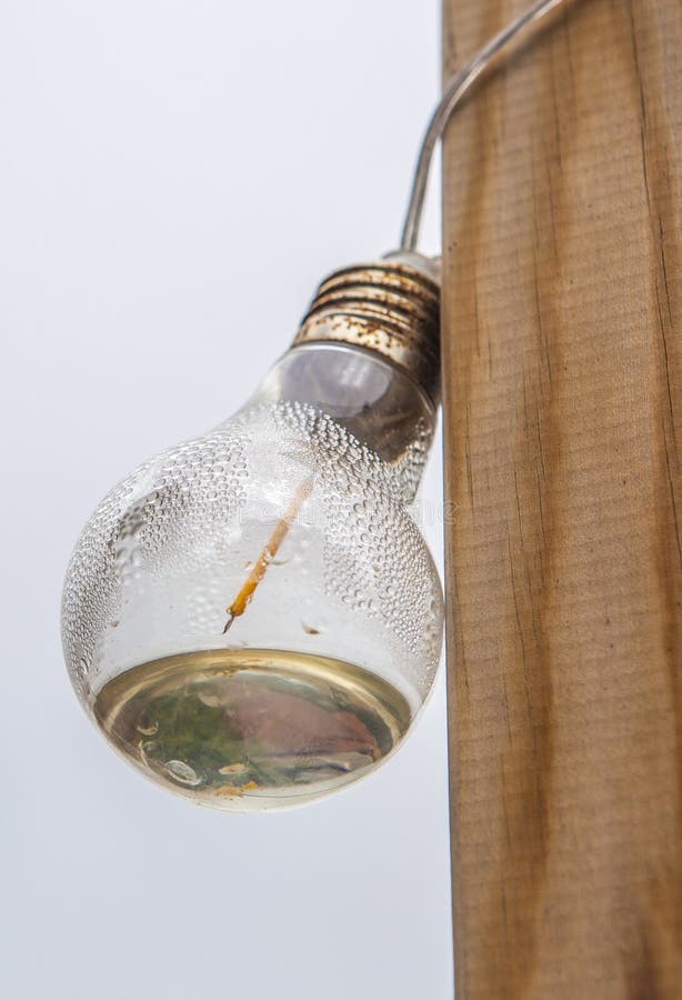 A String of LED Bulbs Hanging from a Wooden Post Stock Photo - Image of ...