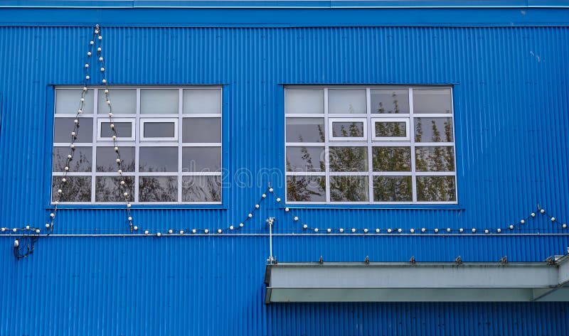 String of Lights on Blue Building Stock Image - Image of architectural ...