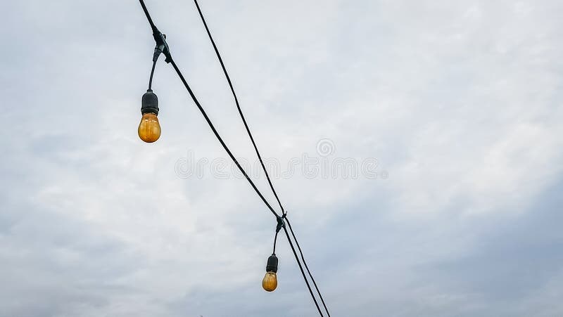 A String of Lights Hanging from a Power Line Stock Image - Image of ...