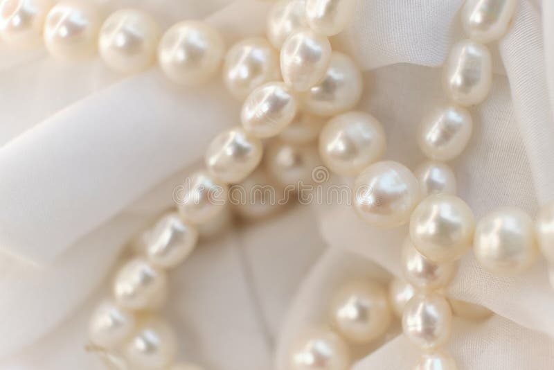 A String of Pearls Gracefully Rests on a White Backdrop, Blurring ...
