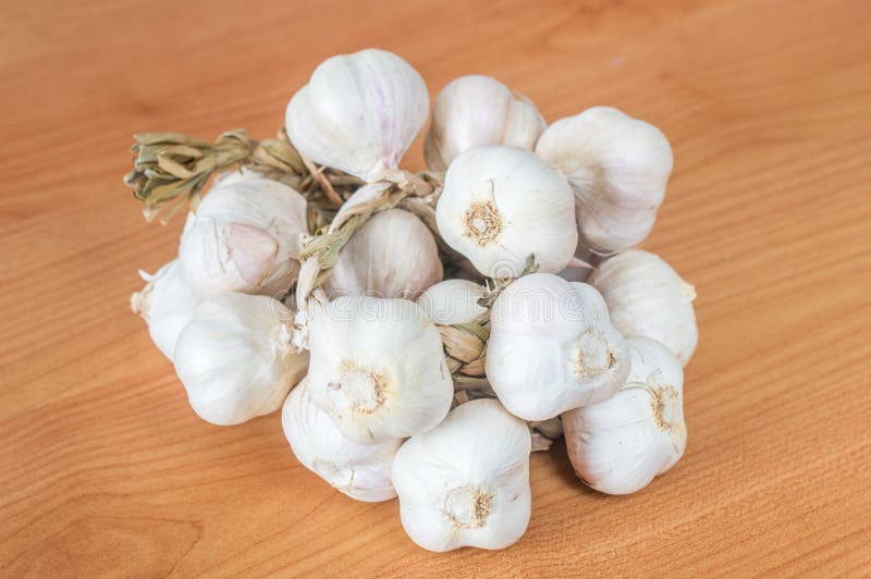 String of Polish Garlic Bulbs at Wooden Table Stock Photo - Image of ...