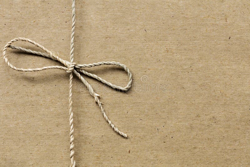 String Bow on Brown Paper stock photo. Image of recycled - 22999590