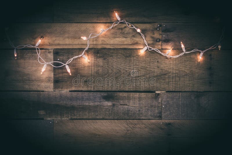A String of White Lights on Aged Wood Background Stock Photo - Image of ...