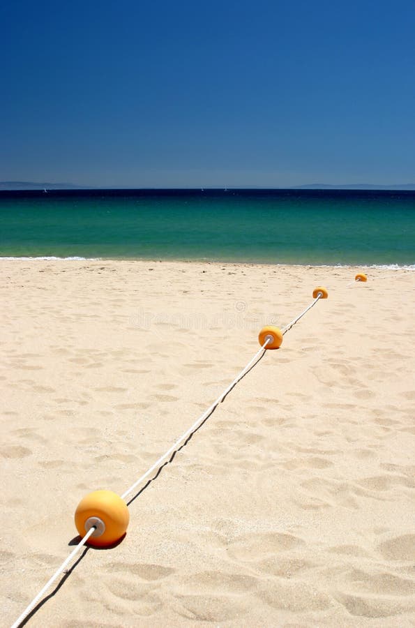 String of Yellow Buoys on Sunny, Sandy Beach Stock Image - Image of ...