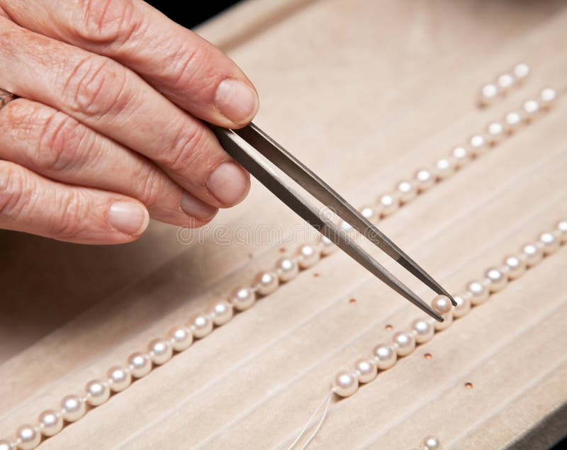 Stringing Pearls on a Necklace Stock Photo - Image of necklace, hold ...