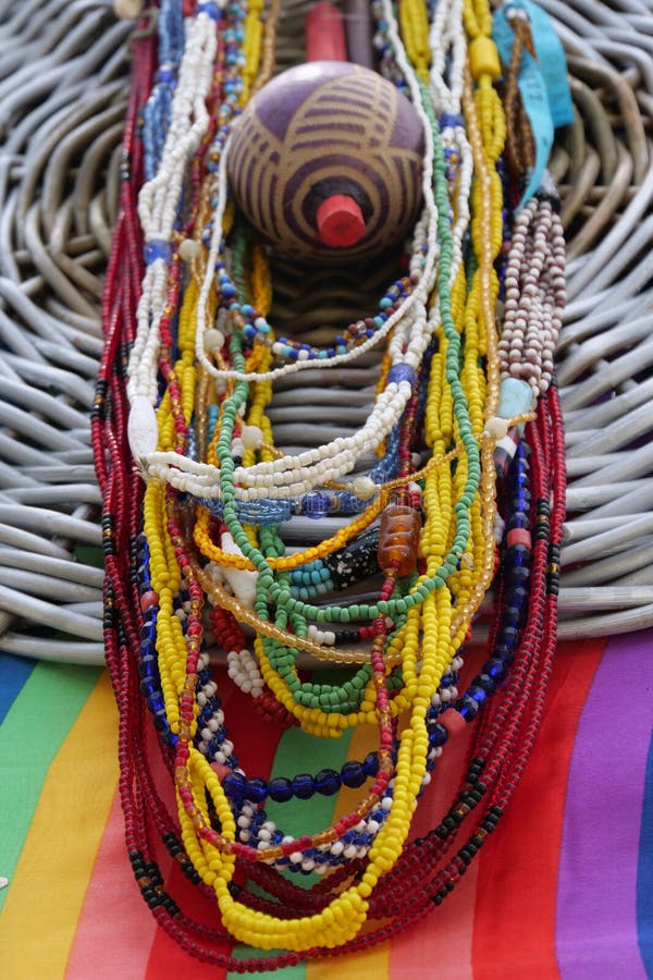Strings of Colorful Glass Beads Hanging Infront of a Basket and a ...