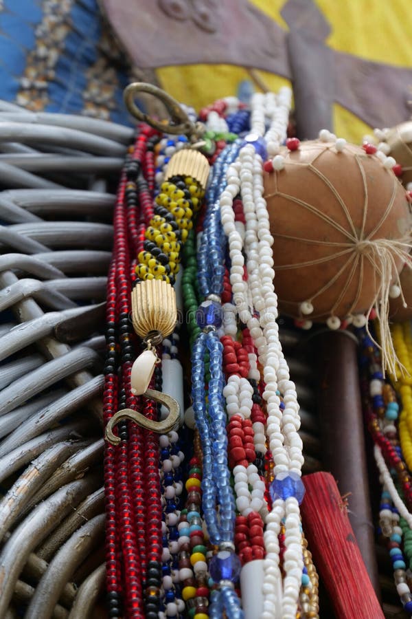 Strings of Colorful Glass Beads Hanging Infront of a Basket. Vertical ...