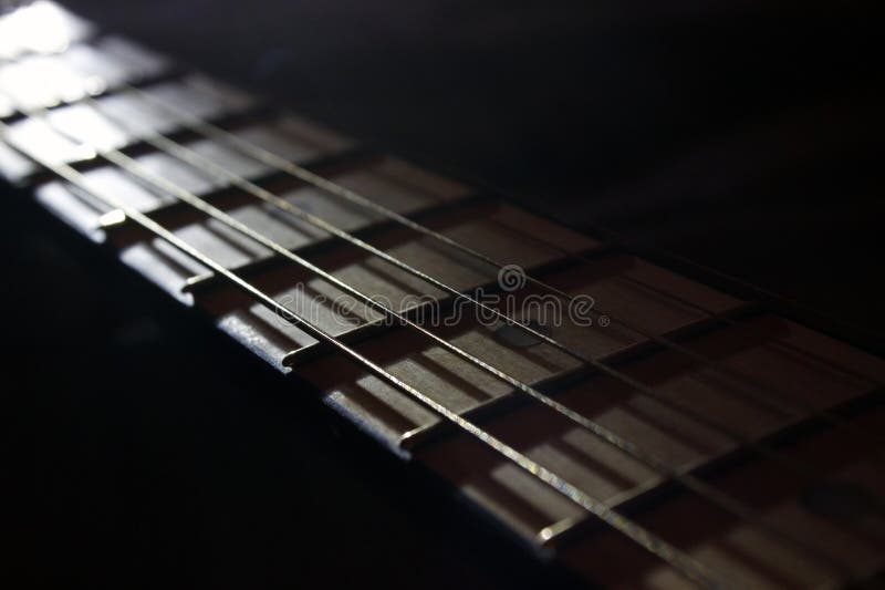 The Strings of a Six-string Guitar Shine in the Dark Stock Image ...