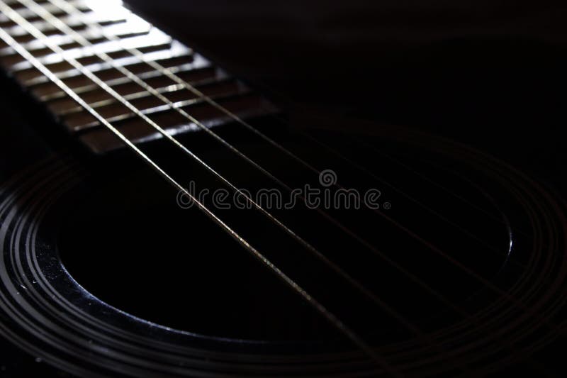 The Strings of a Six-string Guitar Shine in the Dark Stock Photo ...
