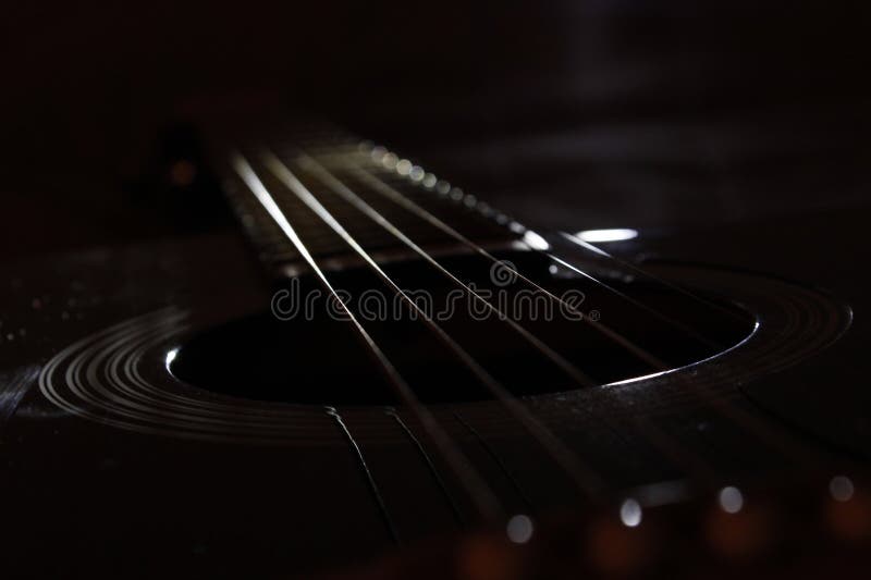 The Strings of a Six-string Guitar Shine in the Dark Stock Photo ...