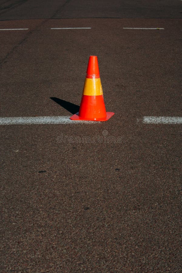 Striped Orange Cone on the Asphalt Road. Stock Photo - Image of signal ...