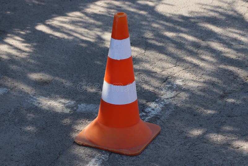 Striped Plastic Cone Stands on the Gray Asphalt Road Stock Image ...