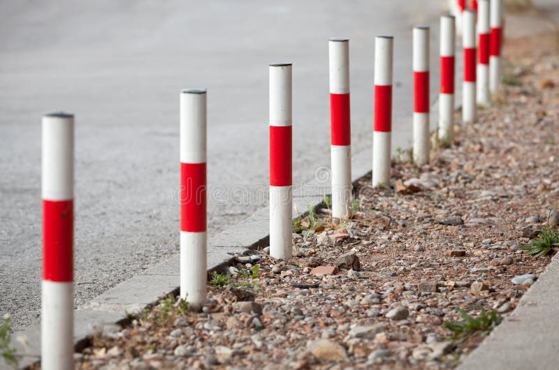 Striped Red and White Signal Poles on Roadside Stock Image - Image of ...