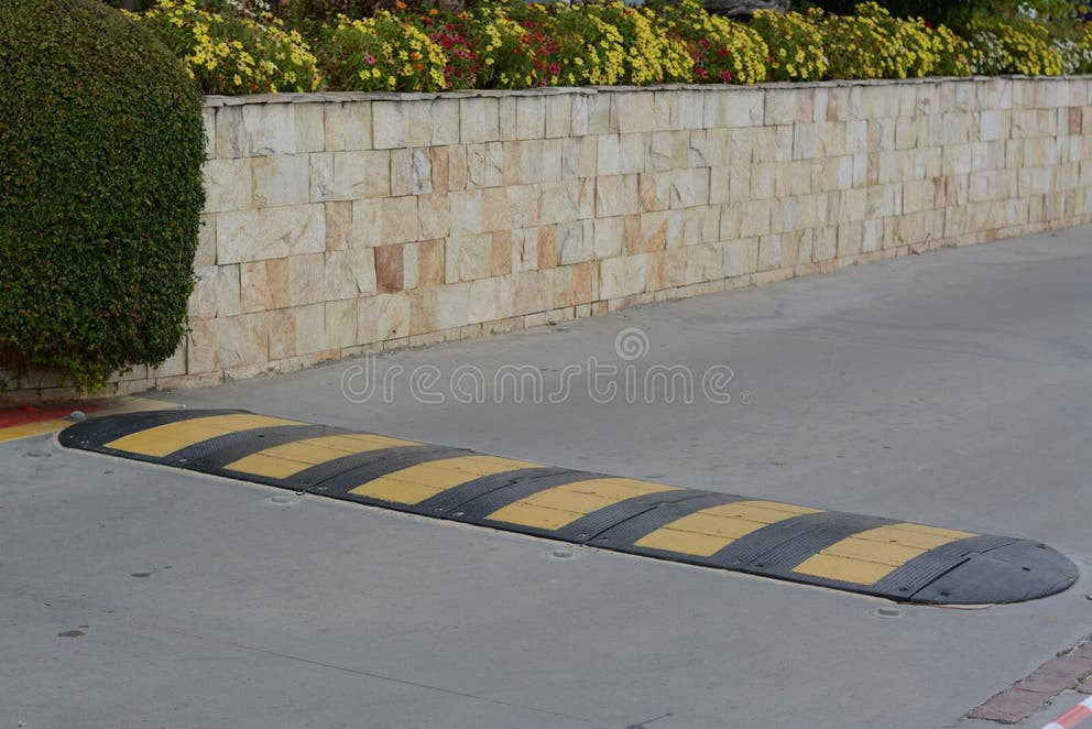 Striped Rubber Sleeping Policeman on Asphalt Road Stock Photo - Image ...