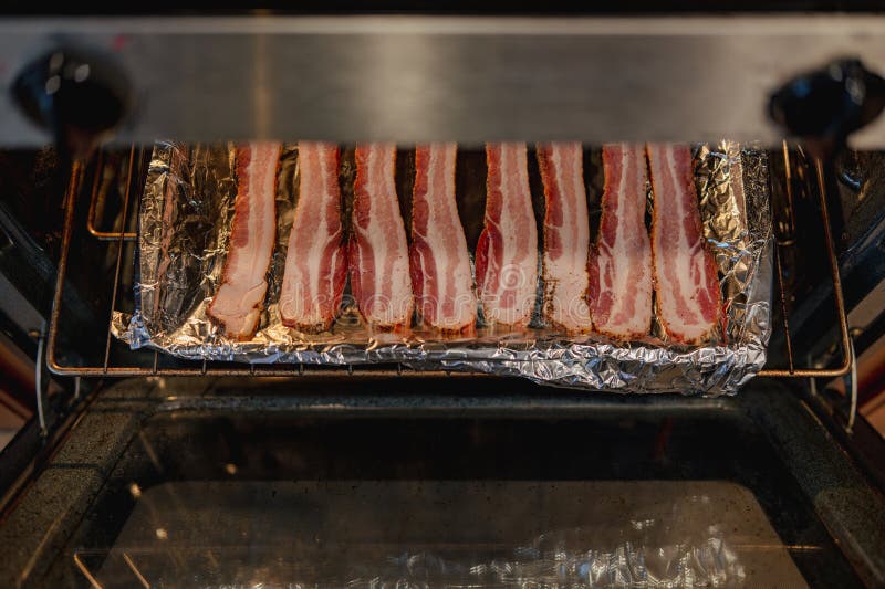 Looking Down at Raw Bacon Going in the Oven To Bake Stock Image - Image ...