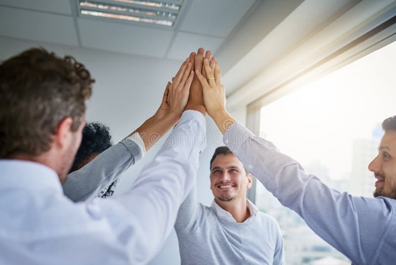 Striving Towards Team Excellence. a Group of Businesspeople High Fiving ... Striving Towards Team Excellence. a Group of Businesspeople High Fiving ...