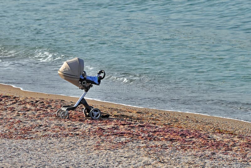 Stroller on the beach stock photo. Image of weekend, pram - 61520754