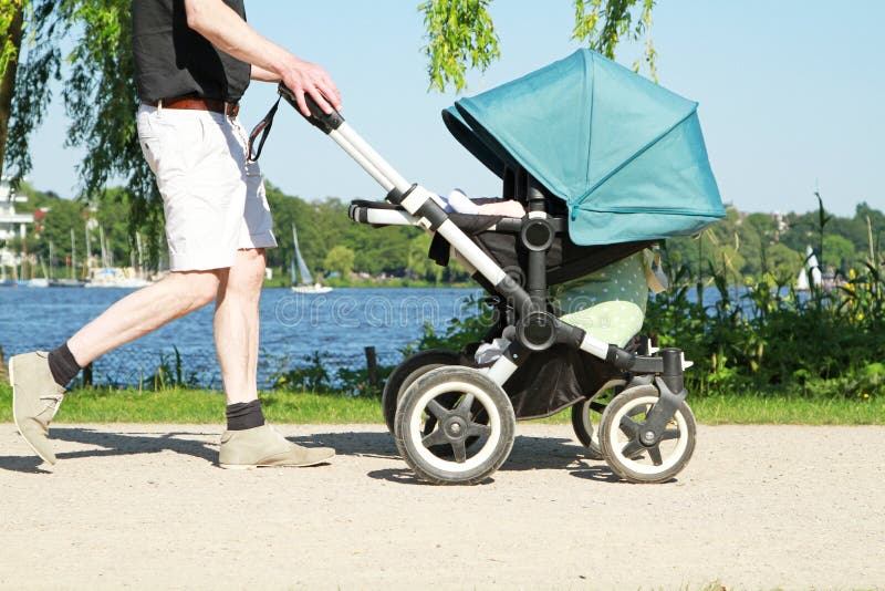 Stroller_Father stock photo. Image of outdoor, baby - 196259558