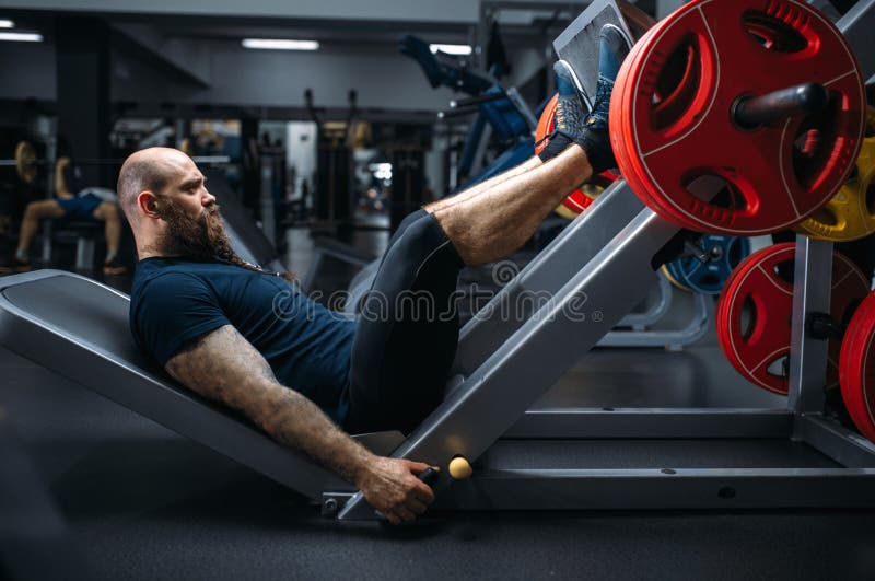 Strong Athlete on Exercise Machine with Barbell Stock Image - Image of ...