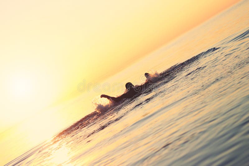 The Strong Man is Swimming in the Lake at Sunset after the Rain Stock ...