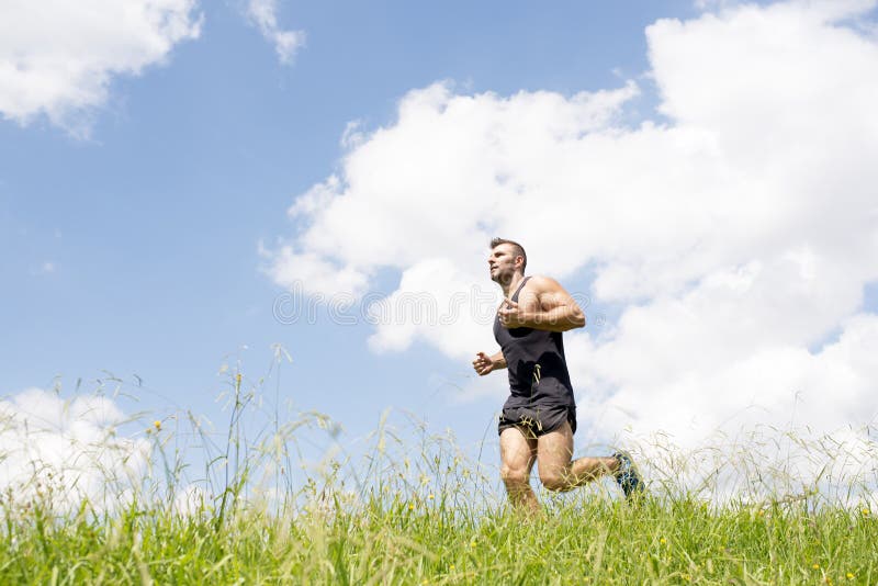Strong Athletic Man Running on the Field. Stock Image - Image of action ...