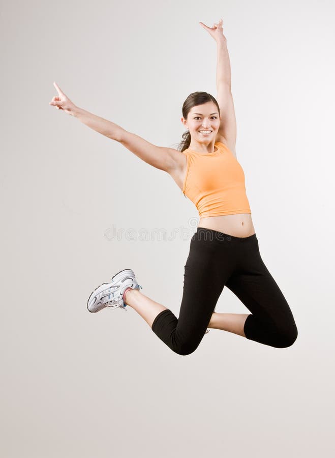 Strong Athletic Woman Excitedly Jumping in Mid-air Stock Image - Image ...