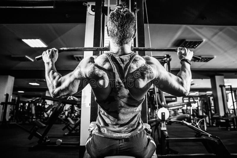 Strong Bodybuilder Doing Heavy Weight Exercise for Back on Machine ...