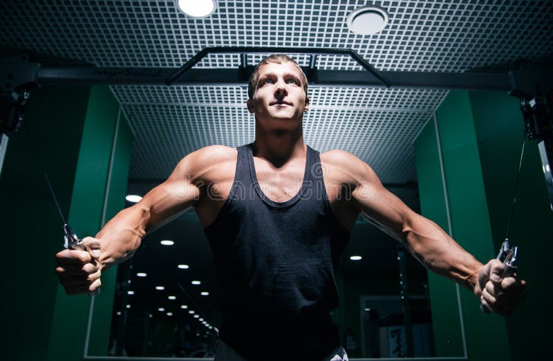 Strong Bodybuilder Doing Chest Exercise with Cable Ropes Stock Photo ...