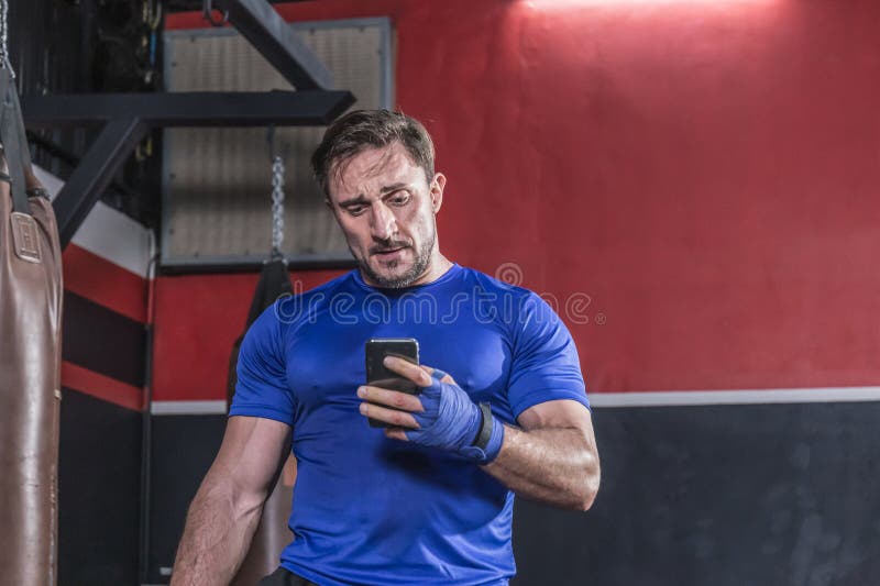 Strong Boxer Man Using Smartphone in Gym Stock Image - Image of club ...
