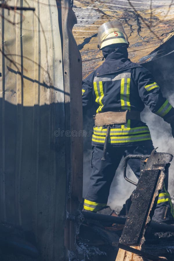 A Strong and Brave Fireman Rescues a Burning Building Using Water in a ...