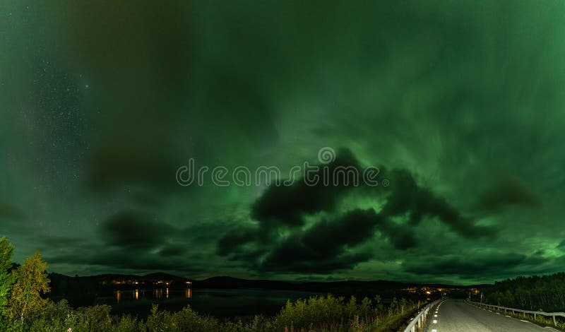 Strong Bright Aurora Borealis Behind Heavy Clouds Over Road Joesjo