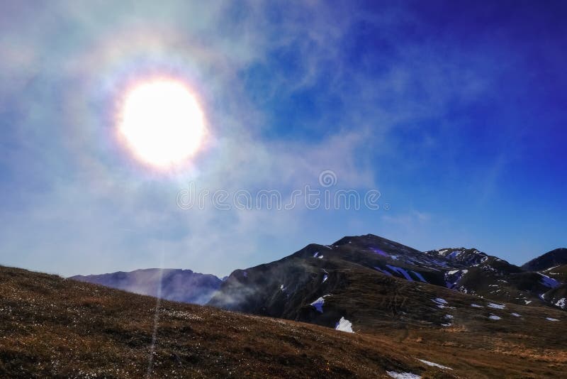 Strong Bright Shining Sun on a Blue Sky with Fog on a Mountain Stock ...