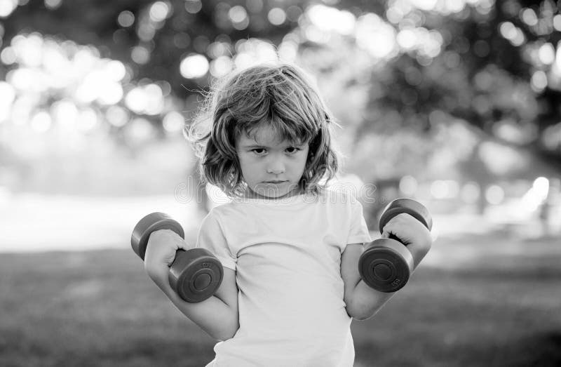 Strong Child Boy is Doing Exercises with Dumbbells in Summer Park ...