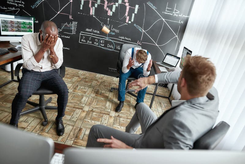 A Strong Desire To Give Up. Three Traders Sitting by Desks in Front of ...