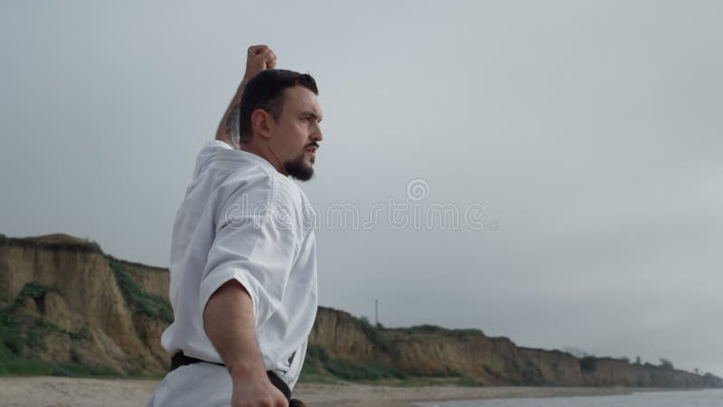 Strong Fighter Practicing Karate on Beach Closeup. Man Training Combat ...