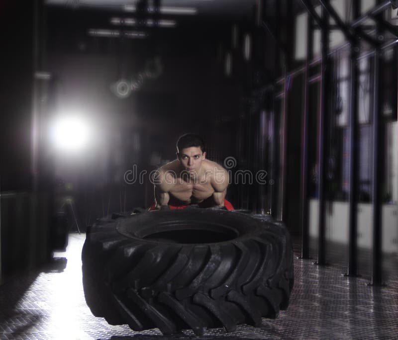 Strong Man Pushing Tire Stock Photos - Free & Royalty-Free Stock Photos ...
