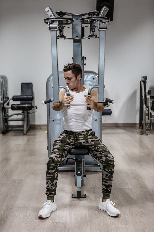Strong Guy Doing Arm Exercise on Machine Stock Photo - Image of stamina ...