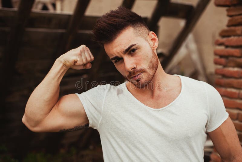 Strong Guy with a Tattoo on His Arm Outside Stock Image - Image of ...