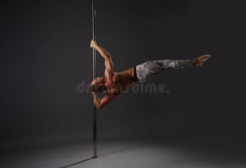Strong Gymnast Exercising on Pylon in Studio Stock Photo - Image of ...
